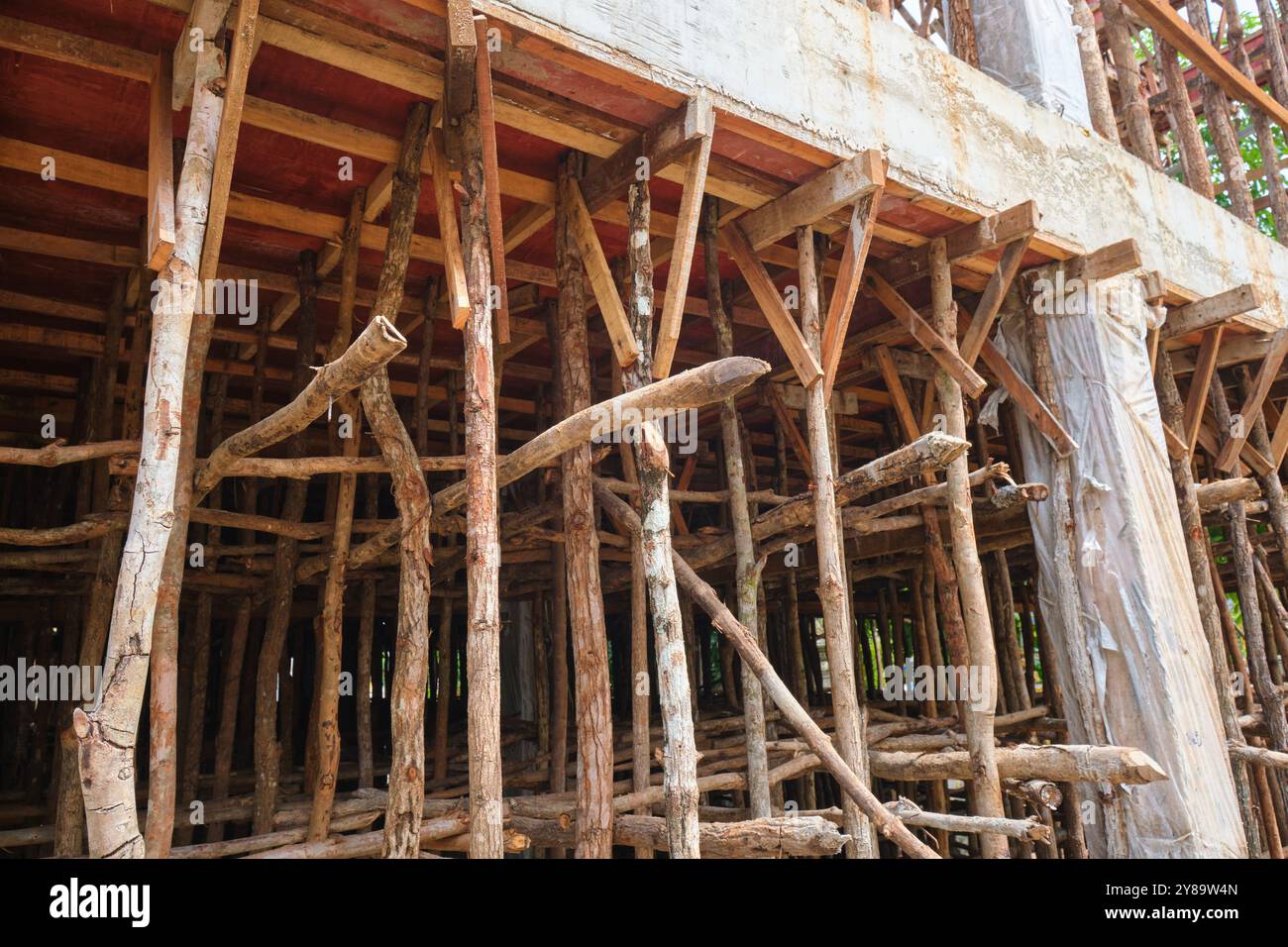 Old construction style concrete form, support work made of wood, logs ...