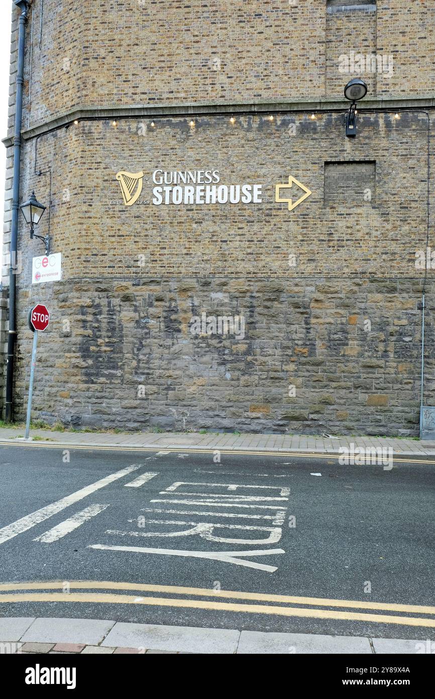 Sign on a brick wall at an intersection directing visitors, tourists ...