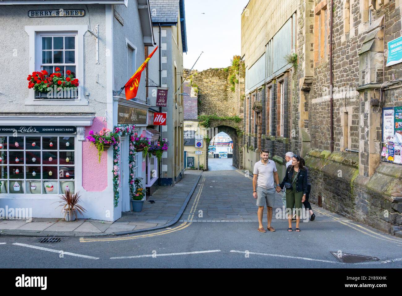 Conwy Wales - July 30 2024; High Street in city with view through old ...