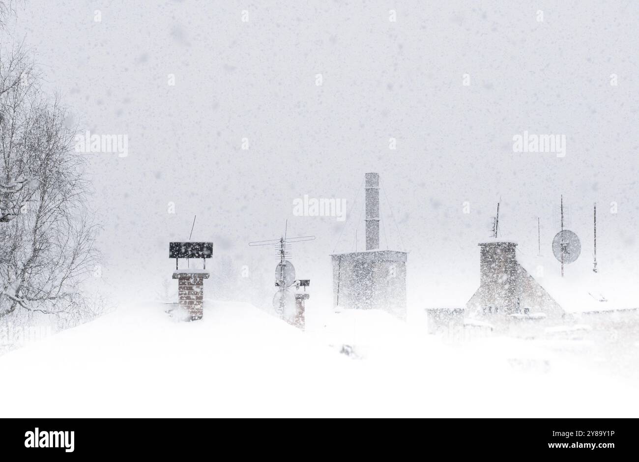 Snowstorm in village. Poor visibility with strong winds Stock Photo - Alamy