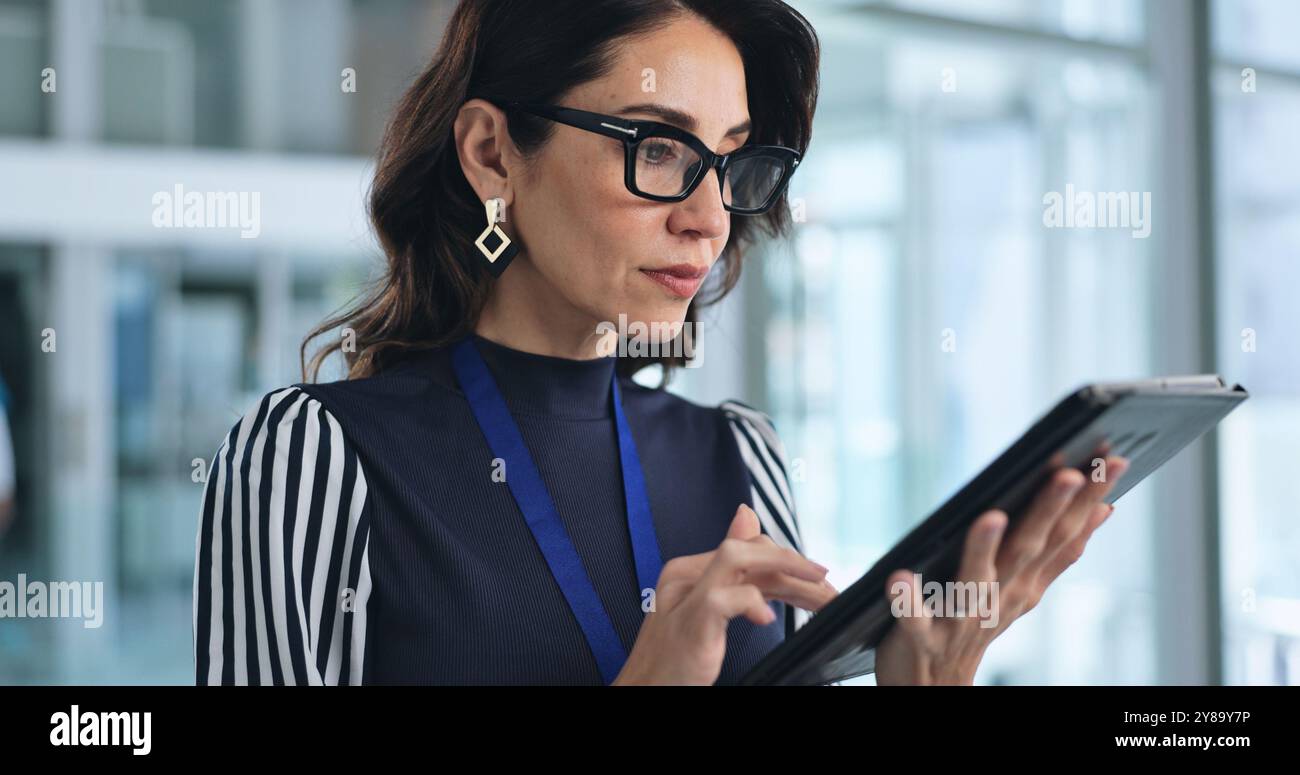 Employee, woman and browsing tablet at office for digital schedule ...
