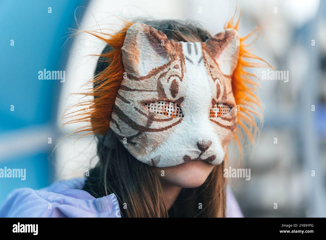 A girl in a cat mask is lying. quadrobics Stock Photo - Alamy