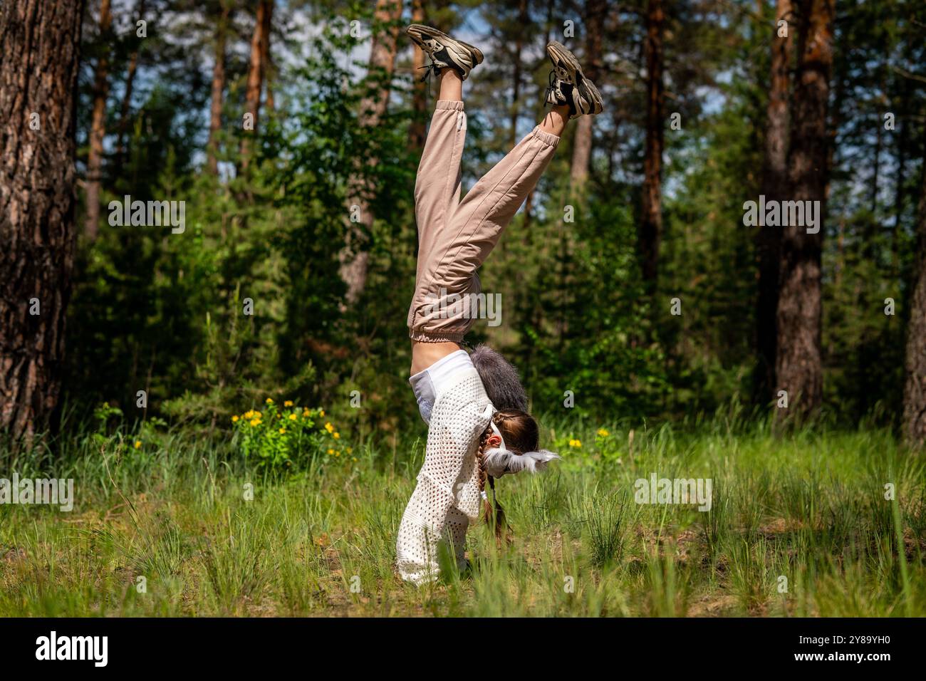 Teenage girl with cat mask and gloves doing Quadrobics. A girl in a cat ...