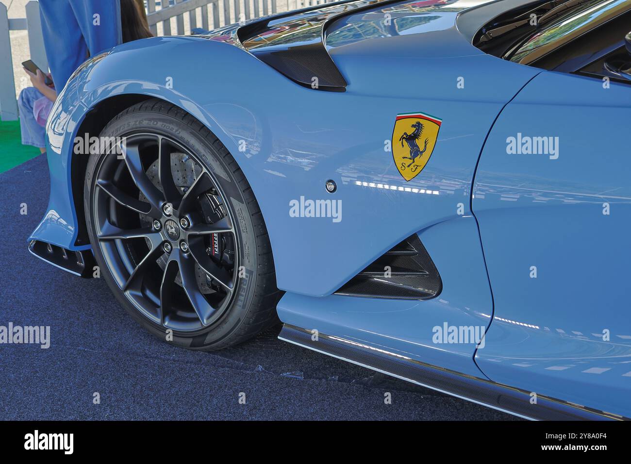 Close up view of a blue ferrari 812 competition sports car with black ...