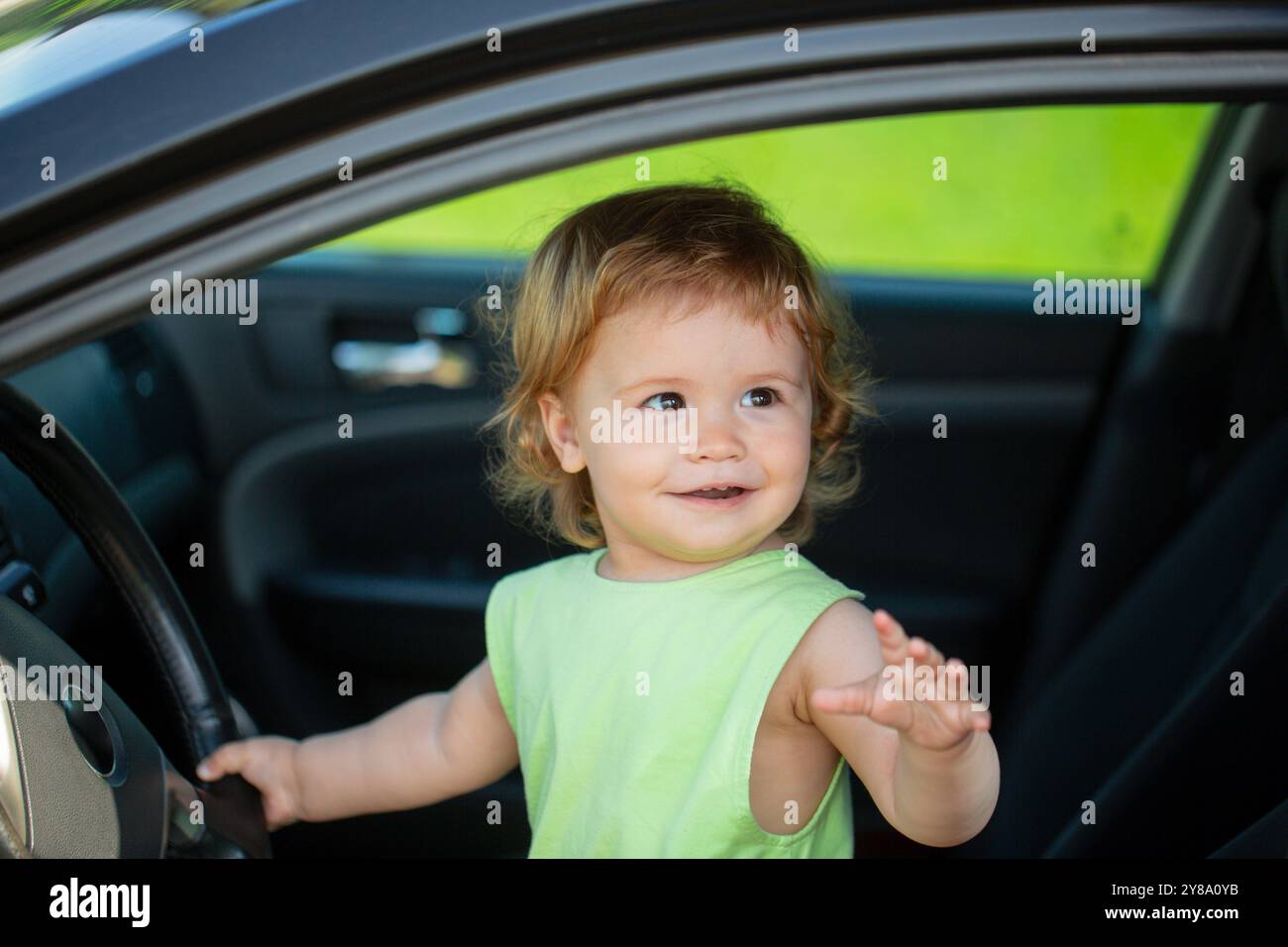 Child Driver. Baby in car with his hands on the wheel. Child Driver ...