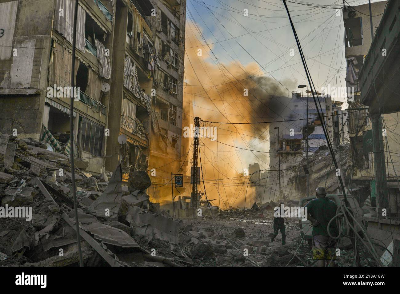 A man runs for cover as a smoke raises in the background following an ...
