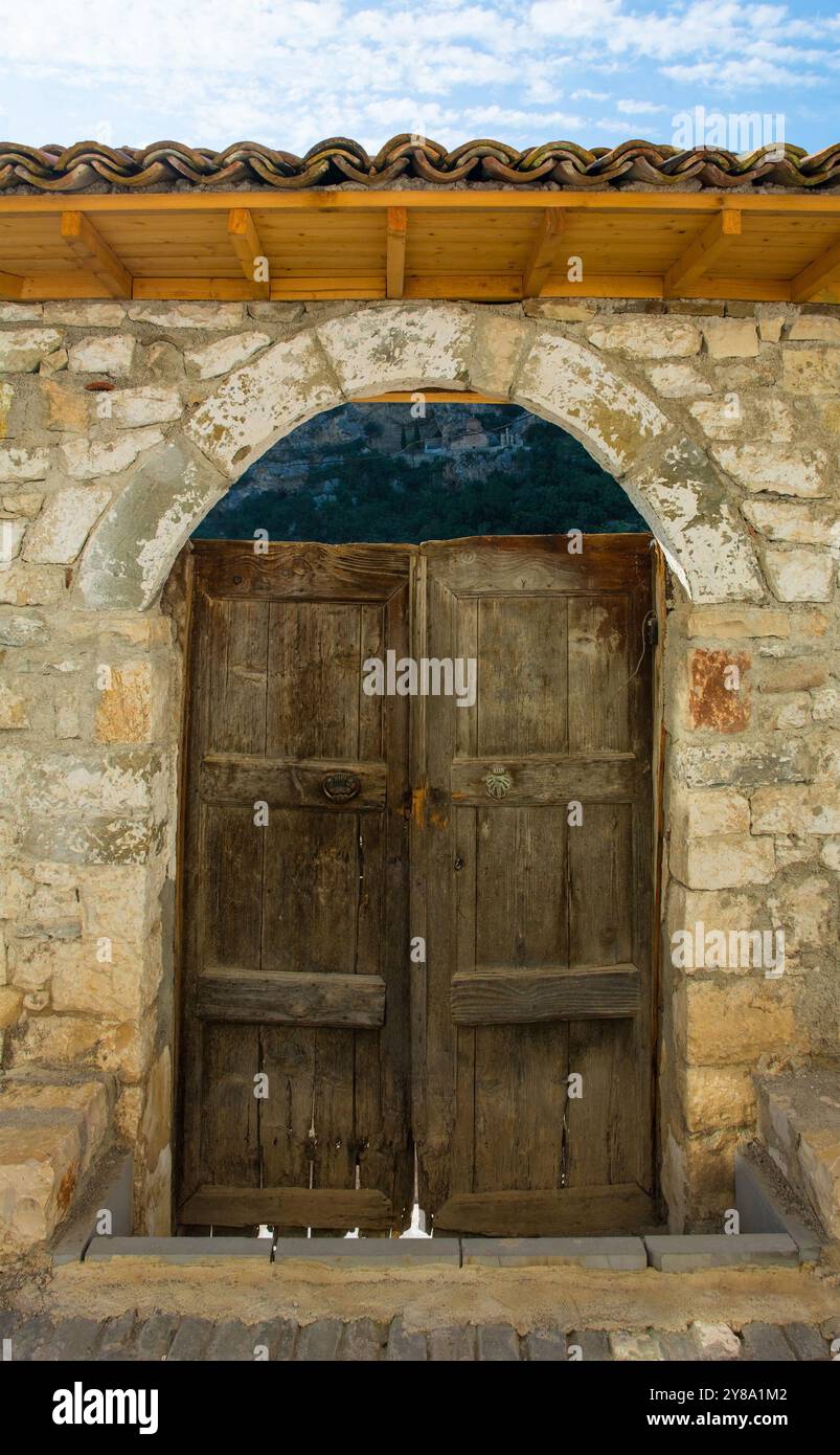 A wooden double door an historic stone garden wall in the Gorica ...
