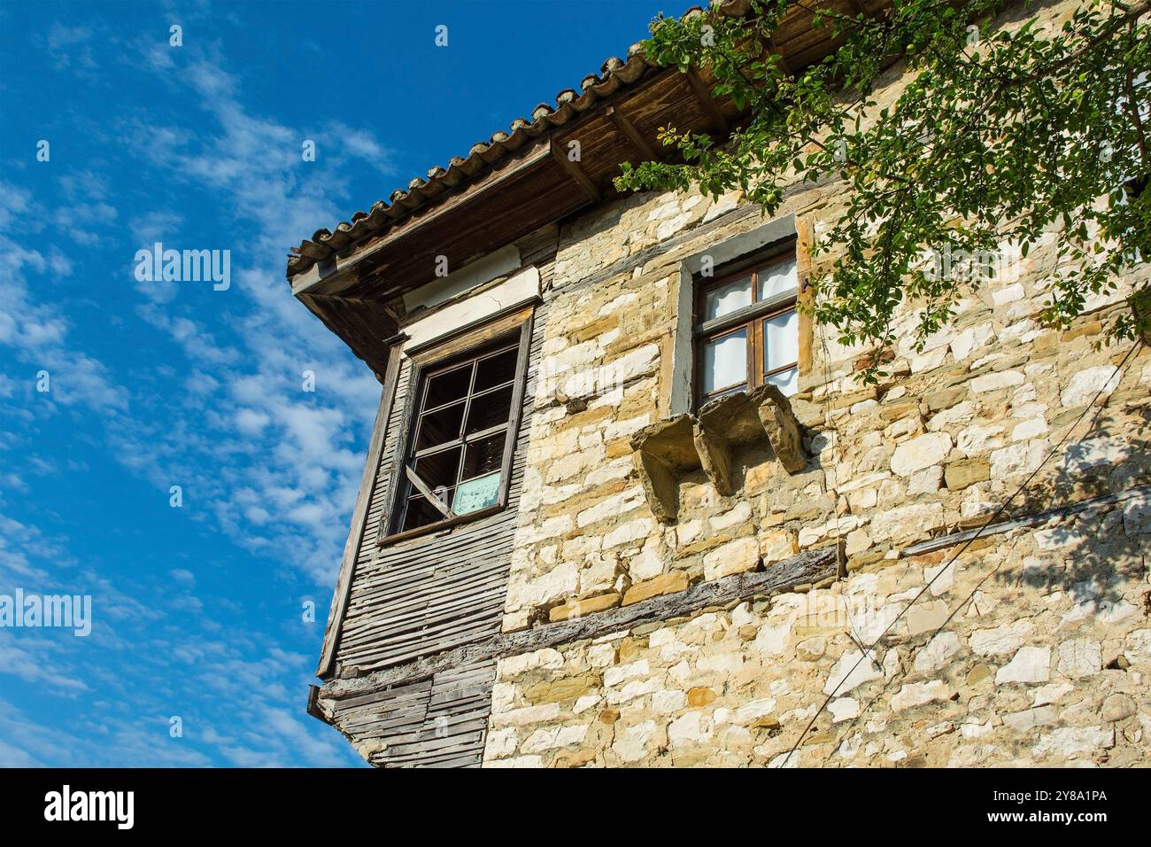 An historic house with half-timbered jettying overhanging a lane in the ...