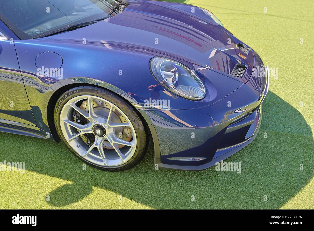 Modern blue porsche 911 gt3 is parked on green grass, showcasing its ...