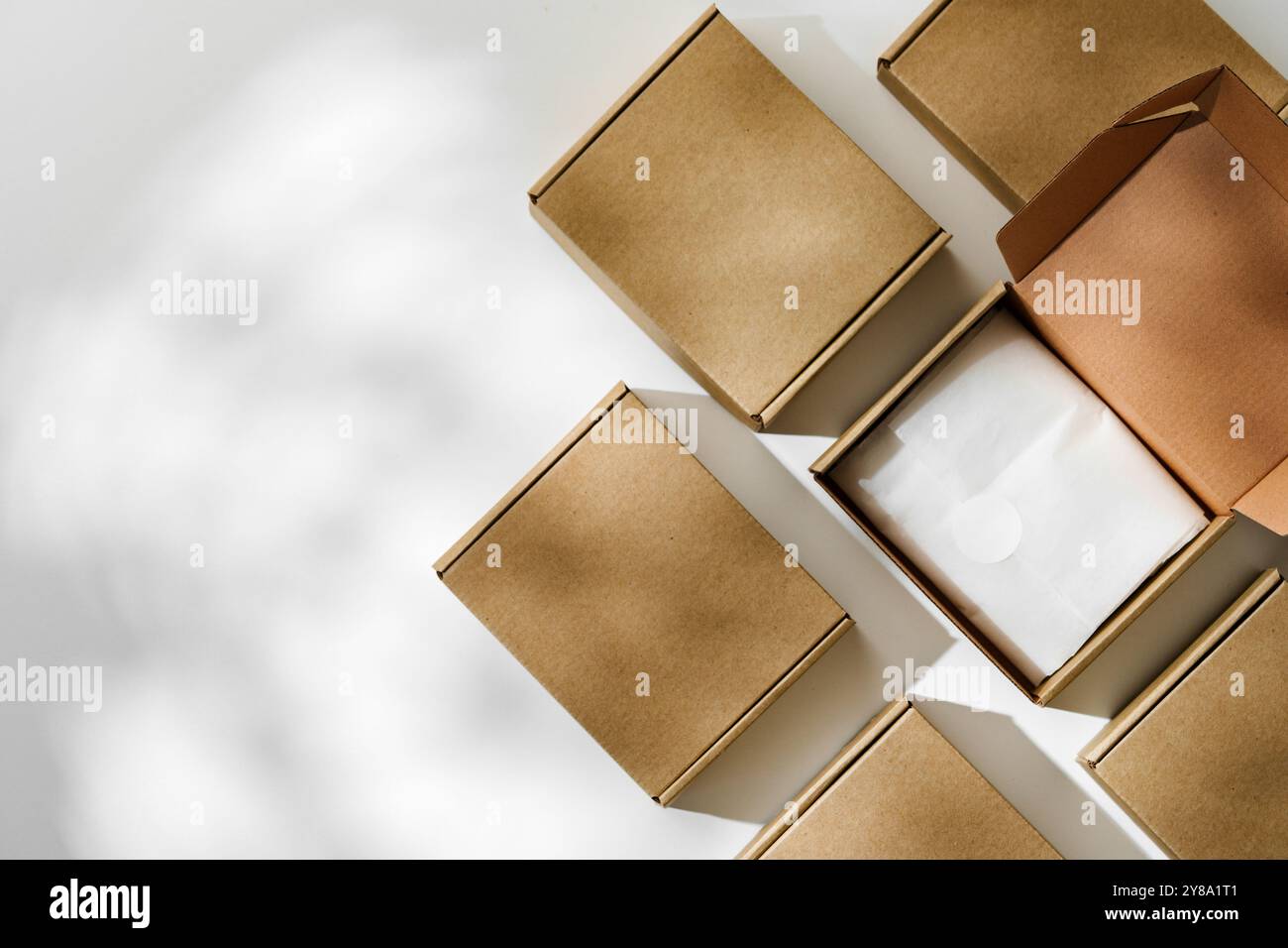Brown cardboard boxes arranged on a neutral background in a warehouse ...