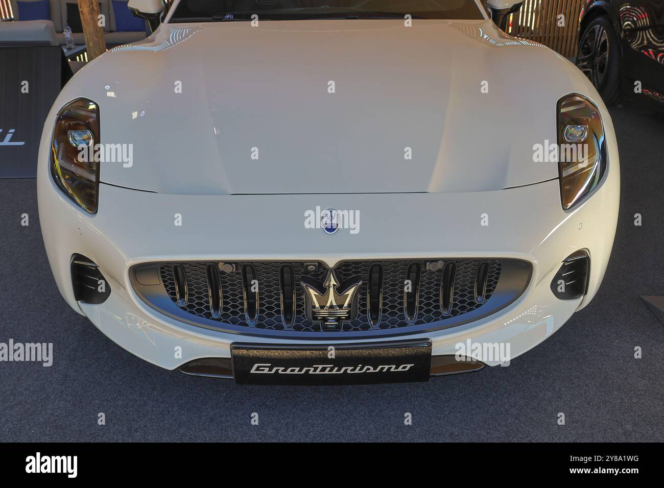 The iconic trident badge takes center stage on a white maserati ...