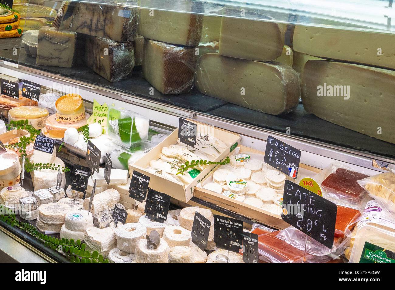 Cheese display in one of the many covered markets in Toulouse which is ...