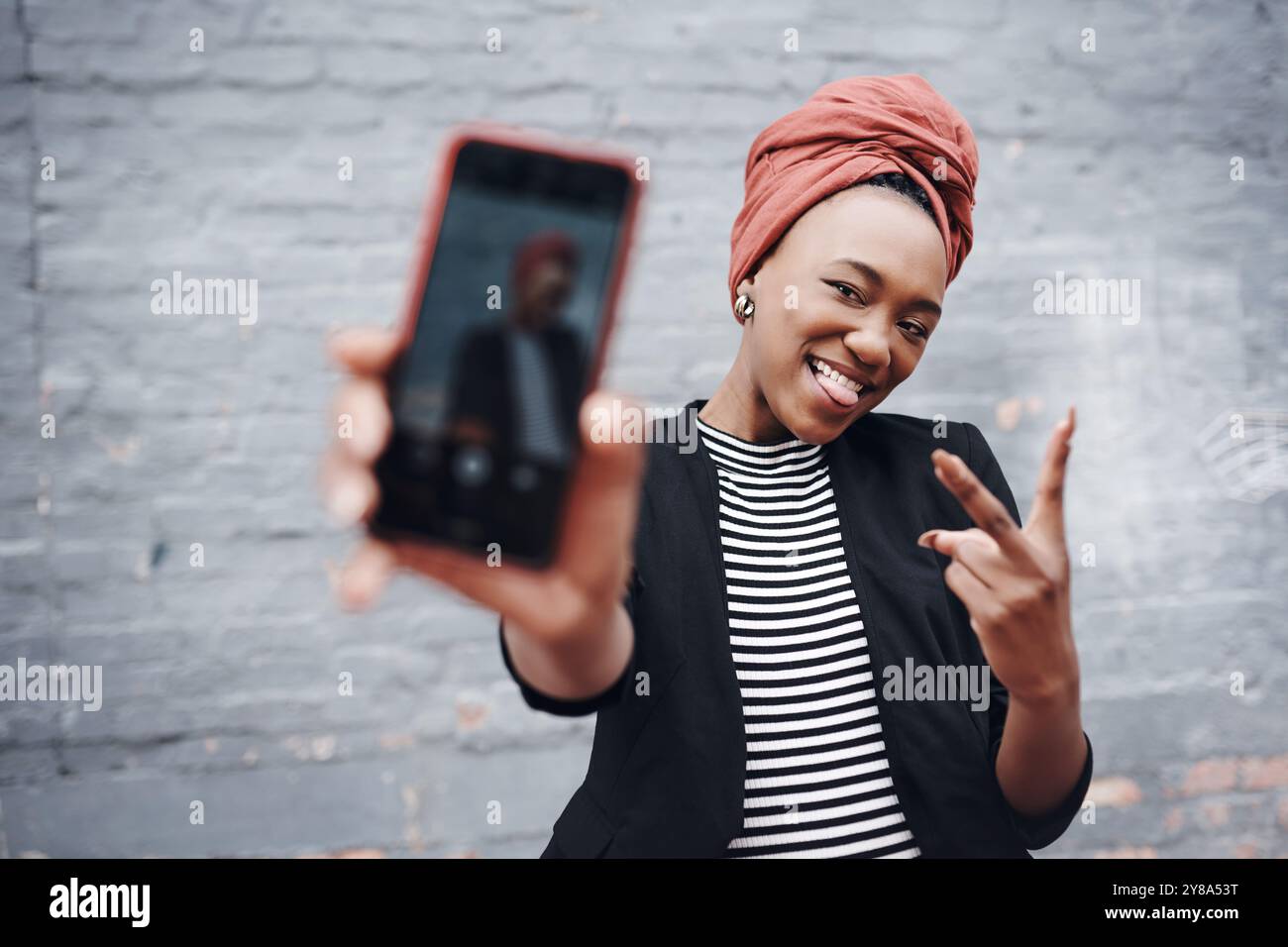 Phone, screen and selfie of black woman with brick wall, smile and ...