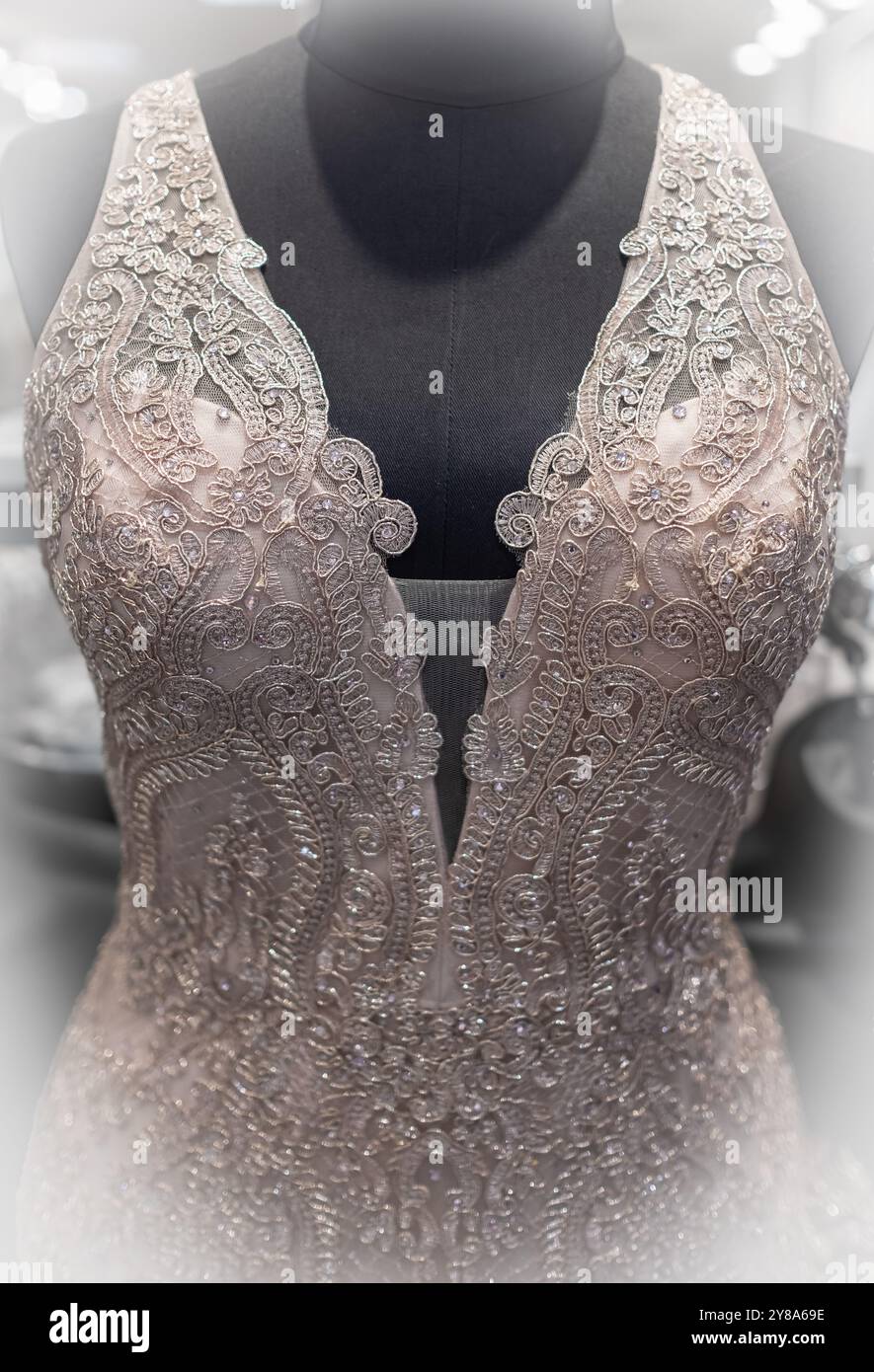 Close-up photo of a wedding dress on a mannequin. Wonderful bridal gown ...