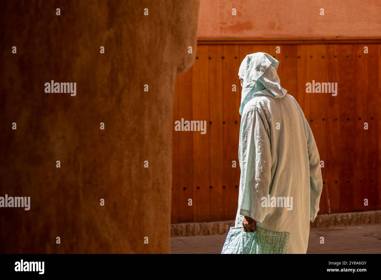 Moroccan woman wearing niqab is walking inside the Marrakech or ...