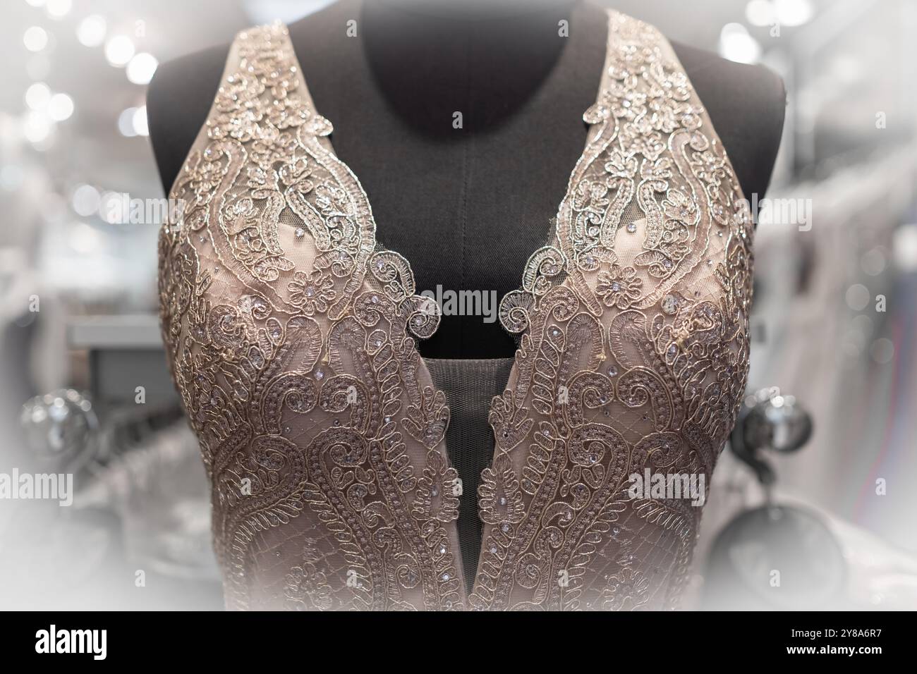 Close-up photo of a wedding dress on a mannequin. Wonderful bridal gown ...