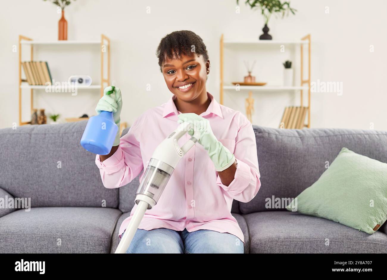 African American happy housewife, maid wearing rubber protective gloves ...