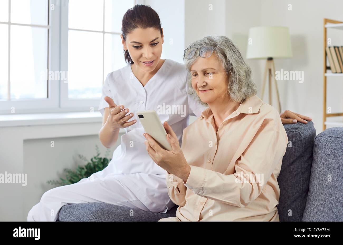Supporting caring kind female medical nurse helping senior patient with ...