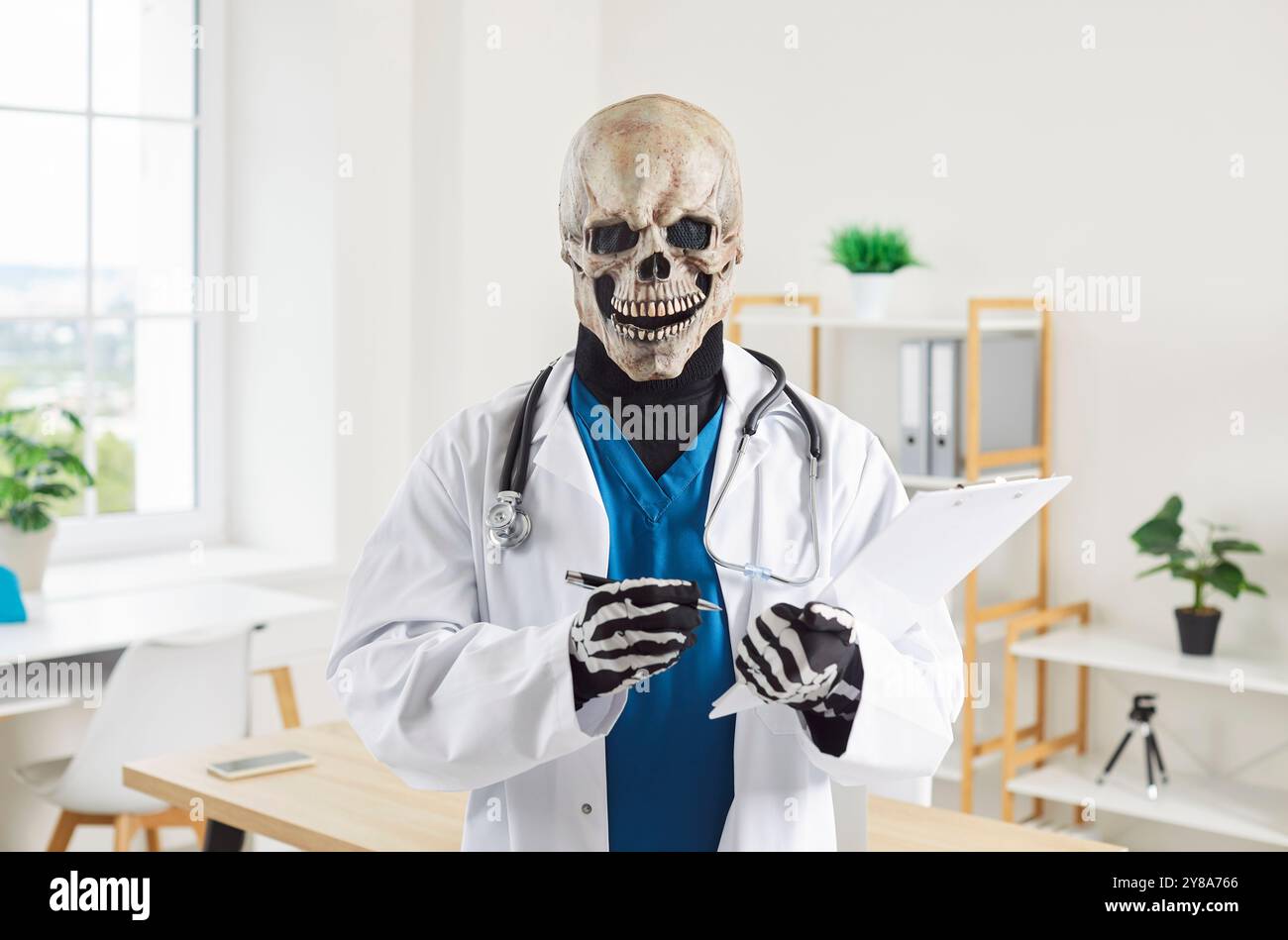 Doctor wearing scull skeleton mask standing in office and looking at ...