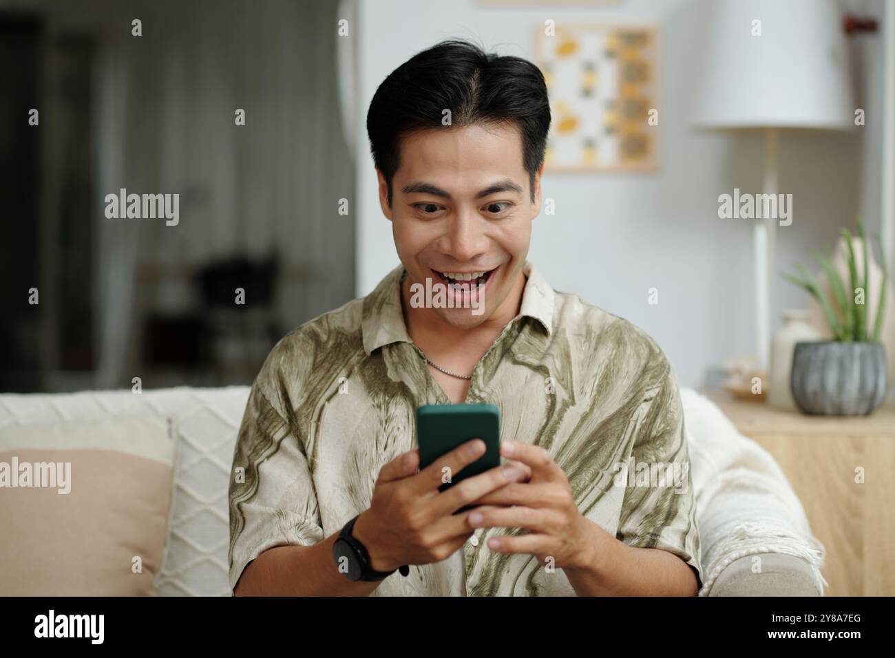 Happy Man Getting Message On The Phone Stock Photo - Alamy