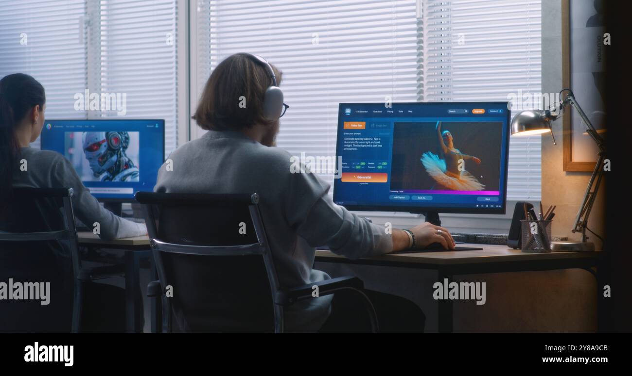 Back view: Two diverse workers using AI generator on computers in ...