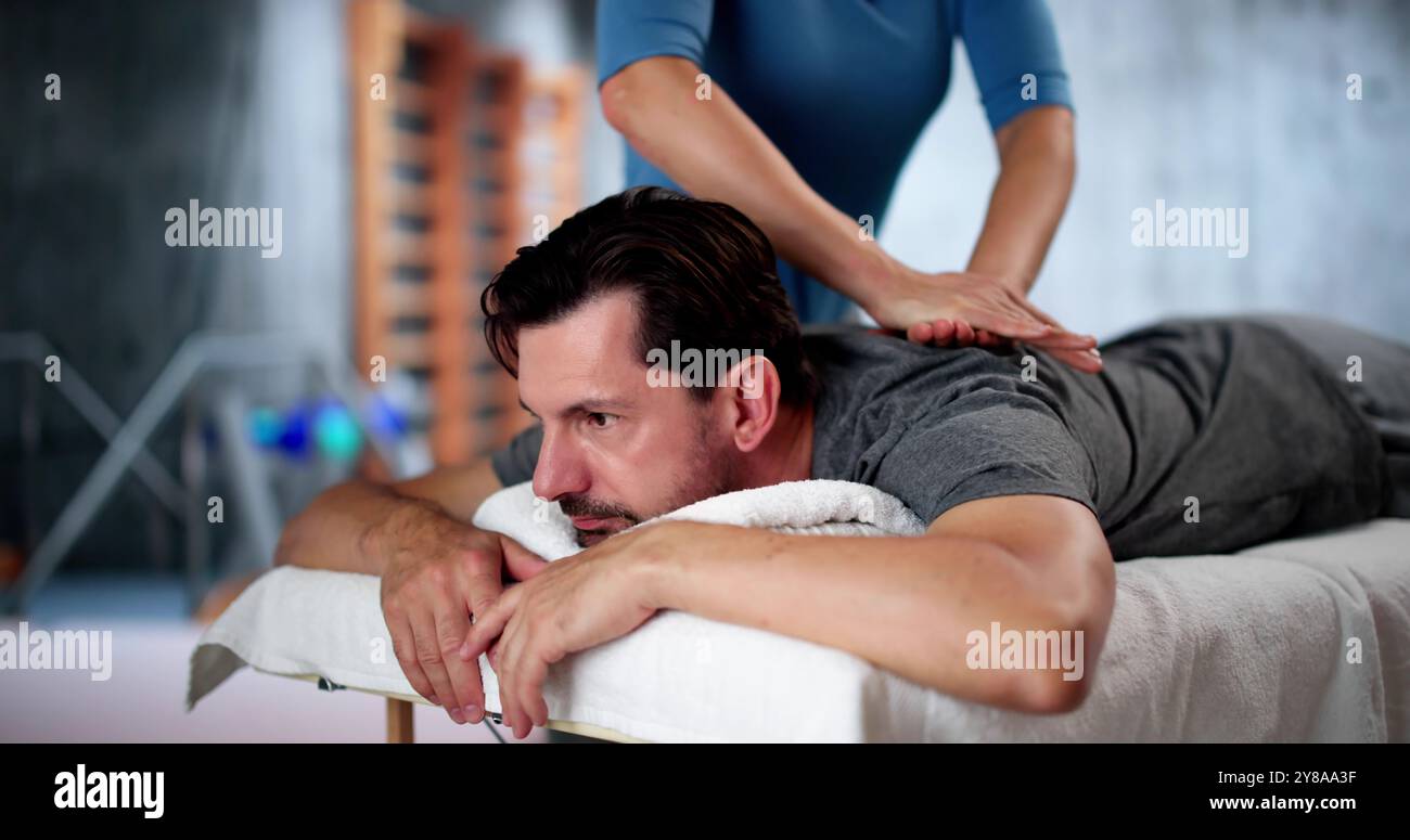 Physiotherapist giving shoulder massage female hi-res stock photography ...