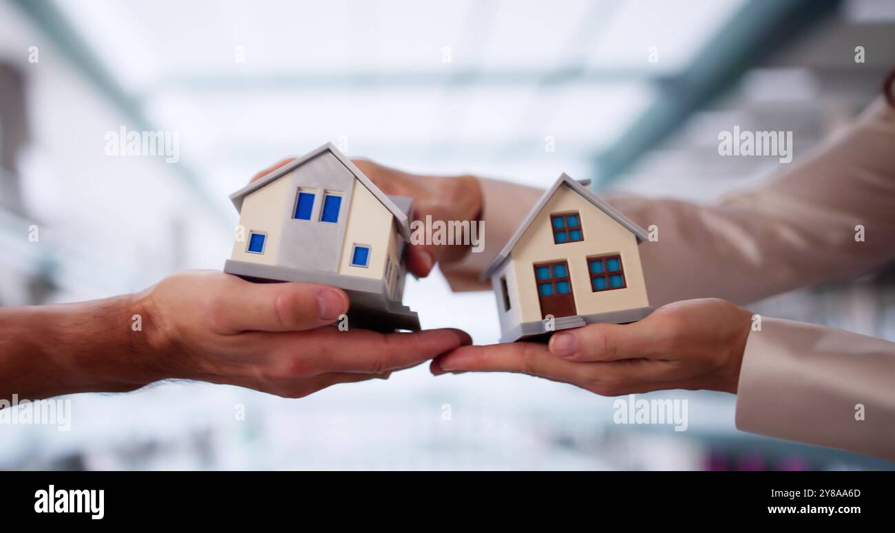 Hand House Swap And Property Insurance Concept Stock Photo - Alamy