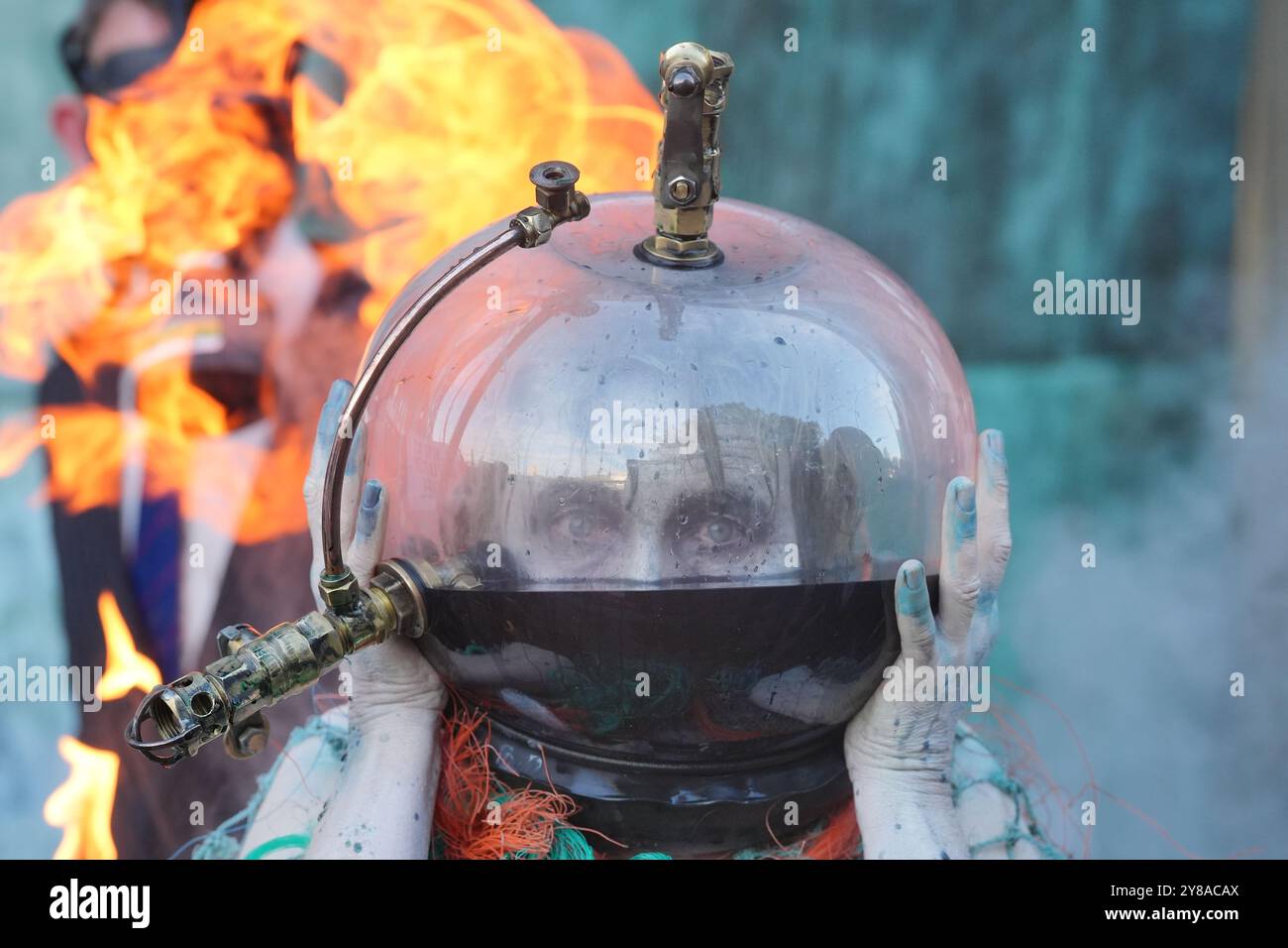 An Ocean Rebellion campaigner, dressed as an oceanic goddess with her ...