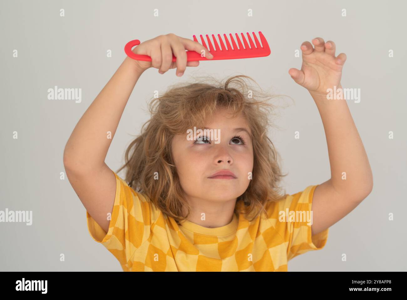 Comb and hair brush concept. Haircare and kids hair styling. Child with ...