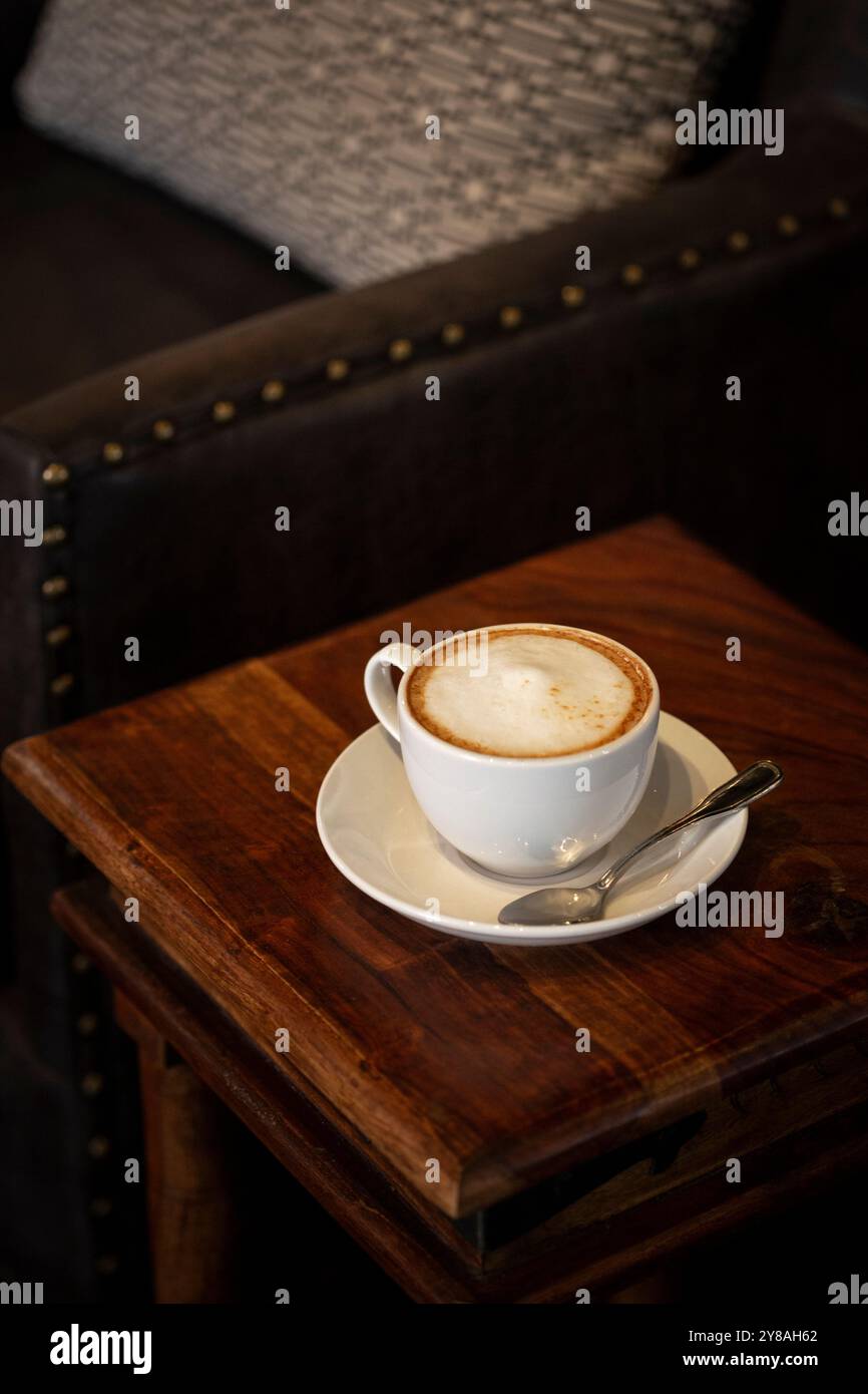 Large cafe latte with foamed milk sitting on side table Stock Photo - Alamy