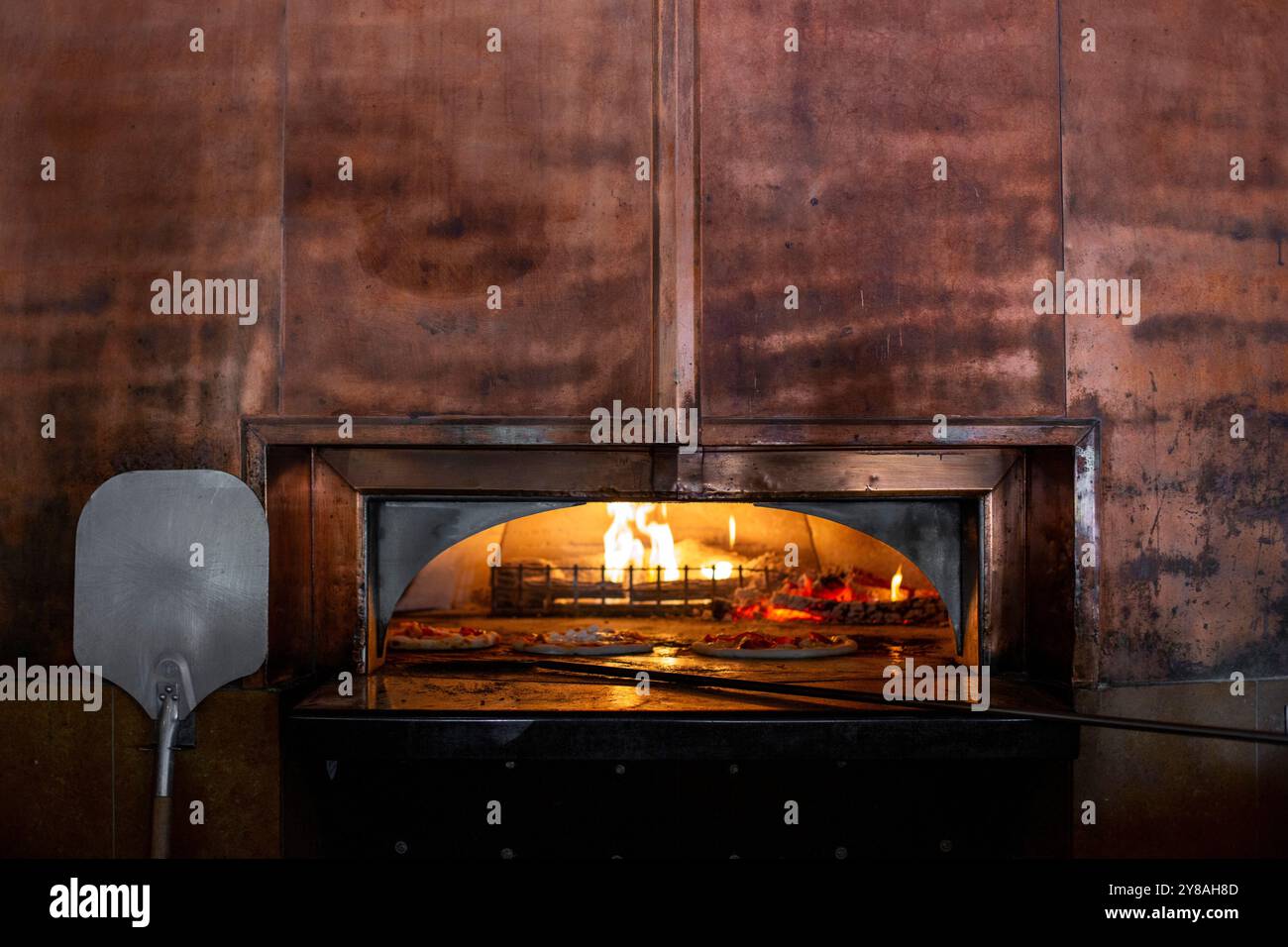 Wood fired brick oven with pizzas cooking Stock Photo - Alamy