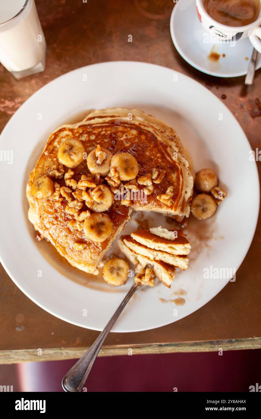 Overhead view of a stack of pancakes with bananas vertical Stock Photo ...