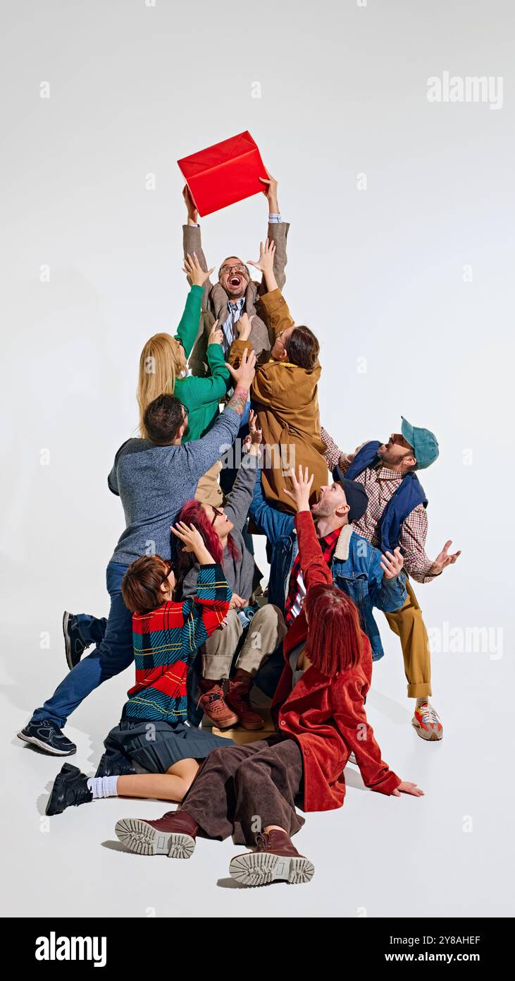 Crowd of people forming a human tower, showing their excitement to get ...