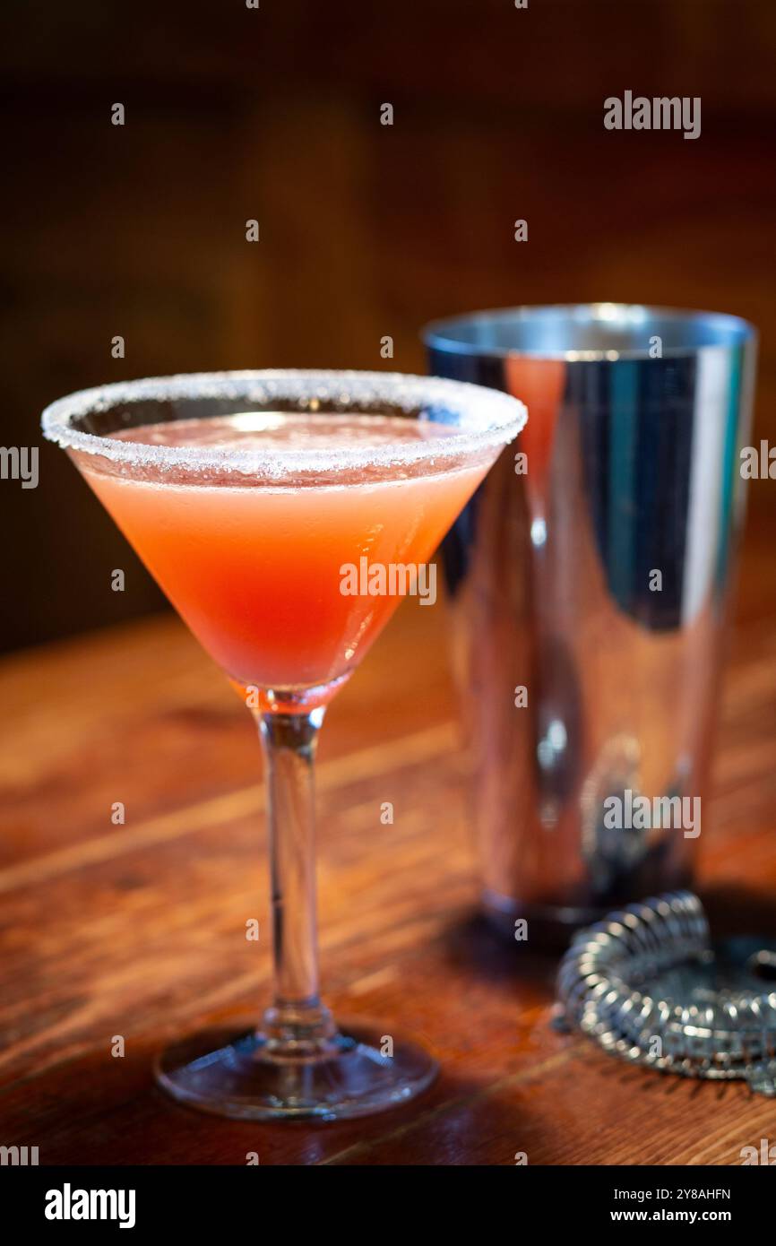 An orange colored cocktail in martini glass vertical Stock Photo - Alamy