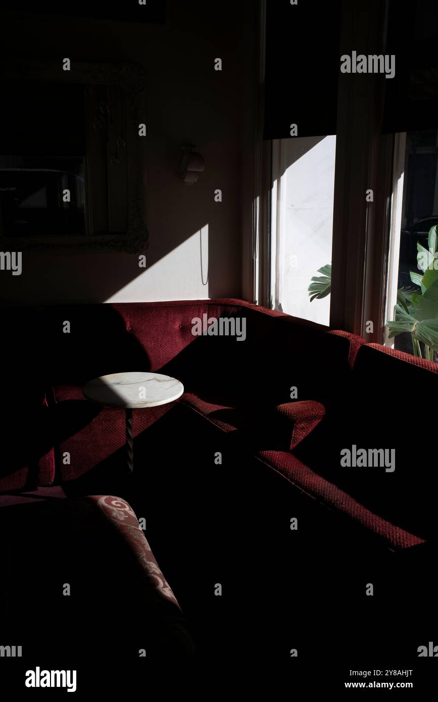 Seating area with dramatic early morning window light vertical Stock ...