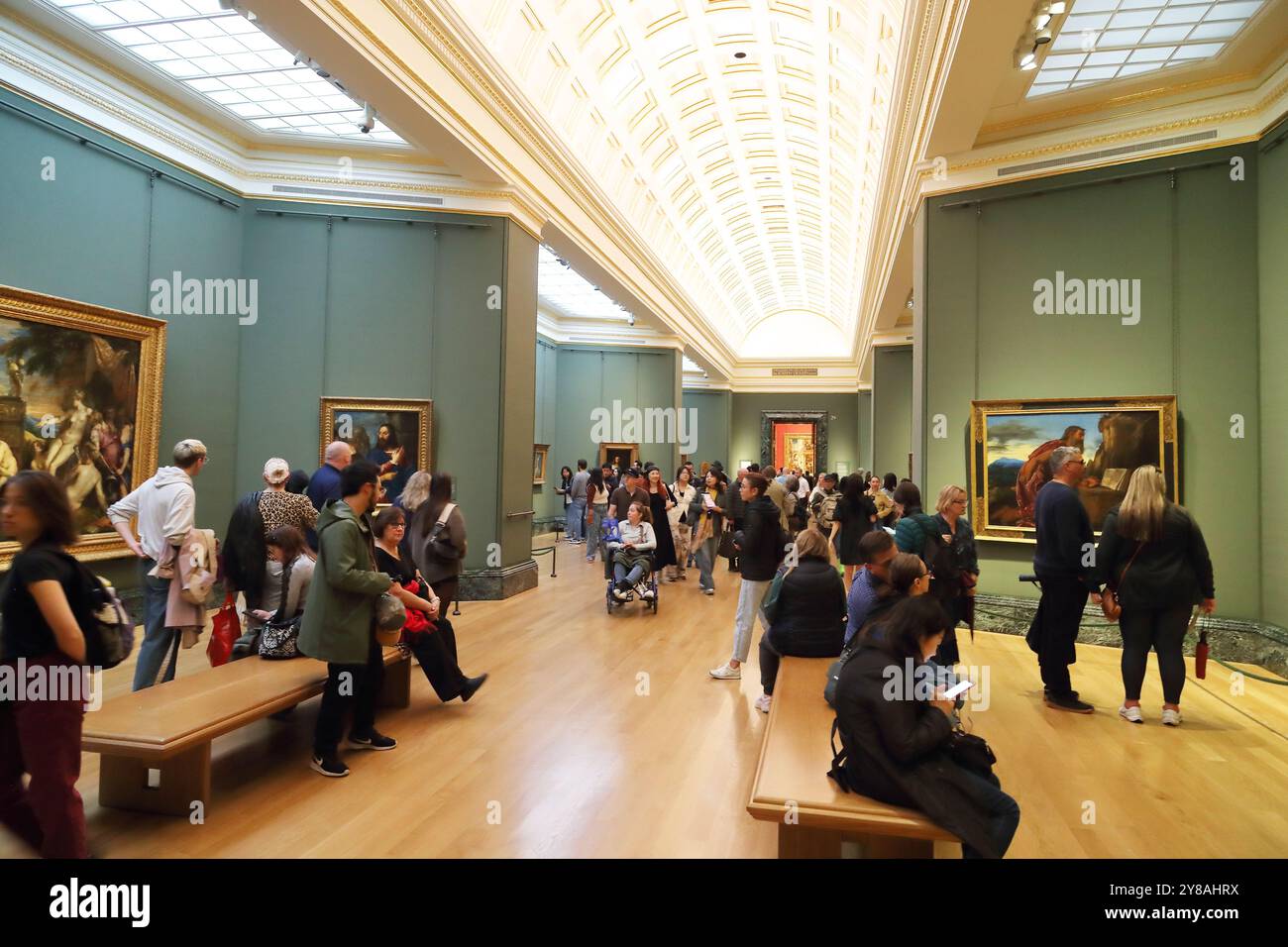 Visitors admiring the artworks at the National Gallery, London, UK ...