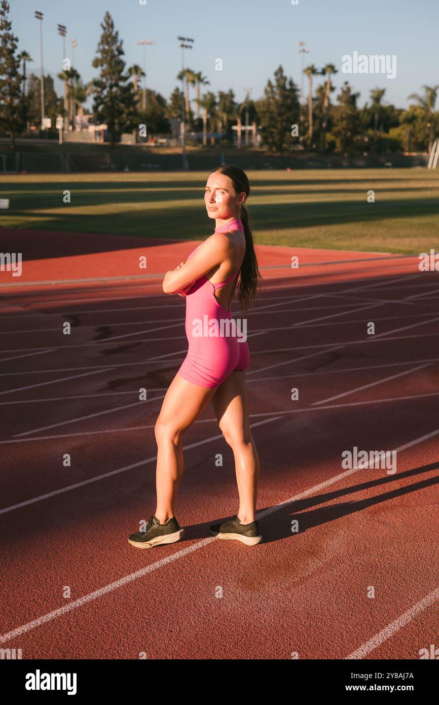 Female athlete posing at the start of the track Stock Photo - Alamy