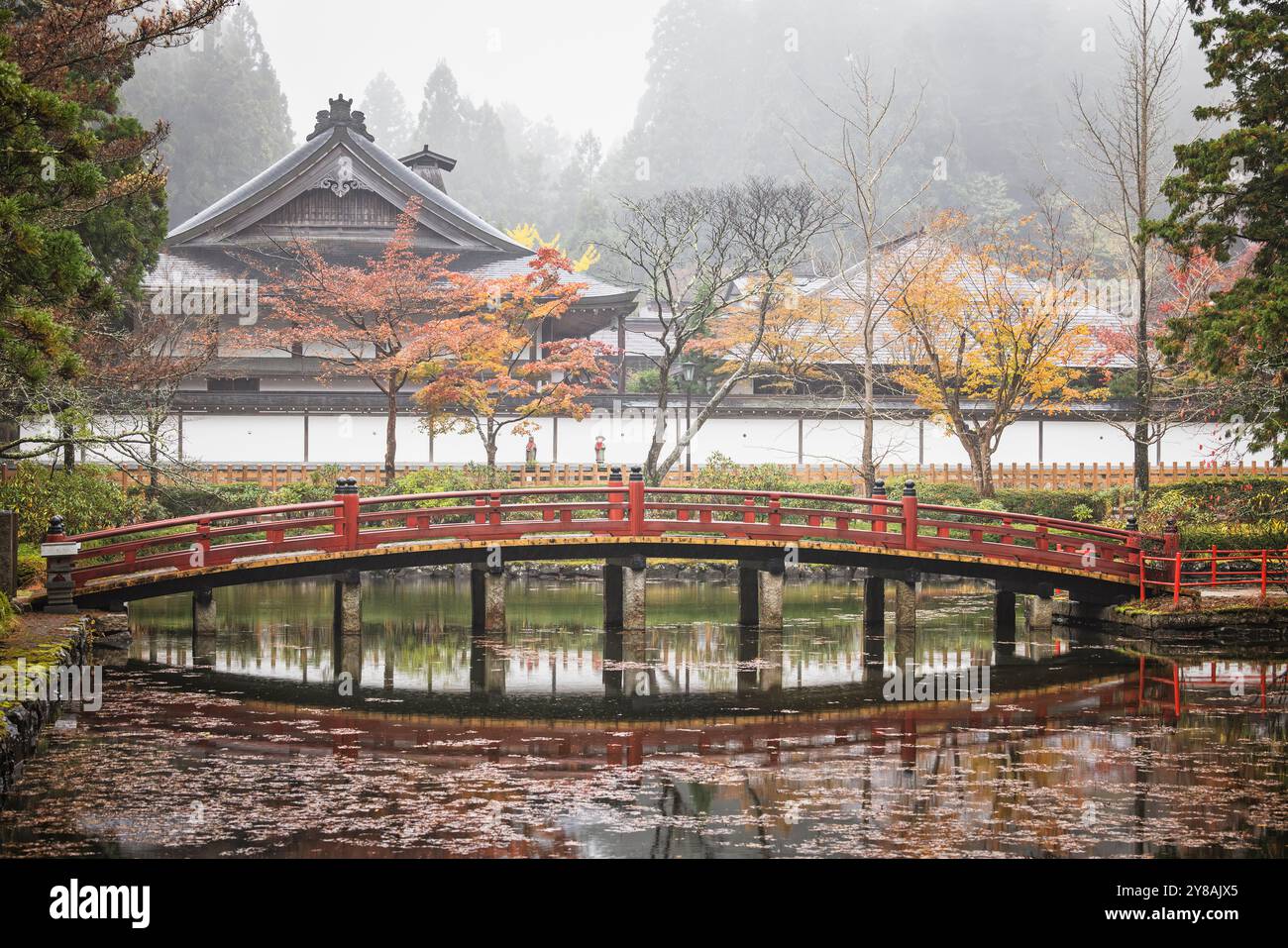 orange bridge with trees and temple Stock Photo - Alamy