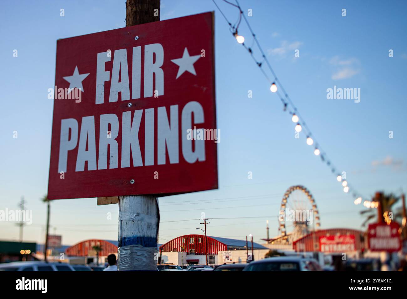 Fair parking sign ferris wheel in background Stock Photo - Alamy