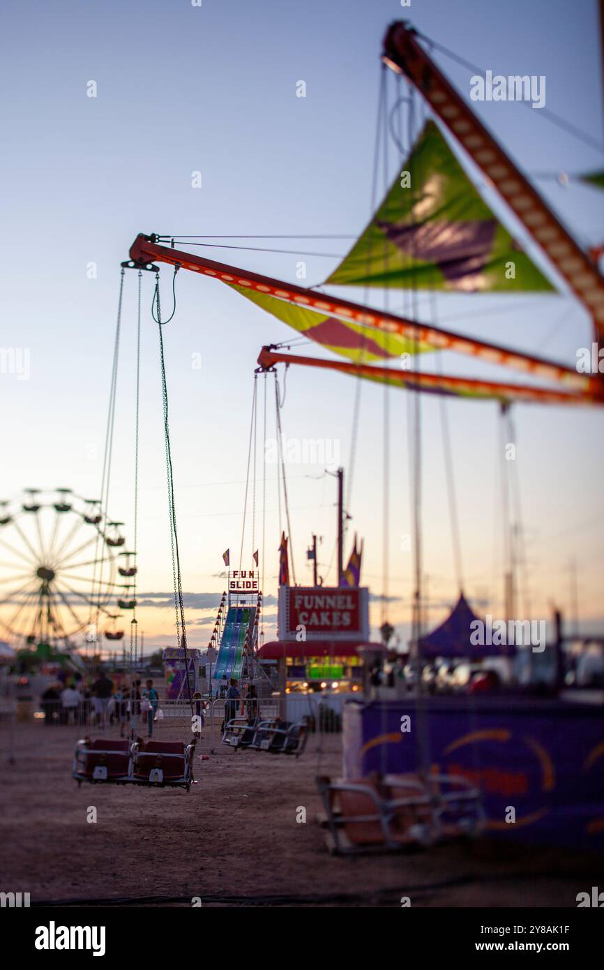 Rides and games at fair grounds sunset vertical Stock Photo - Alamy