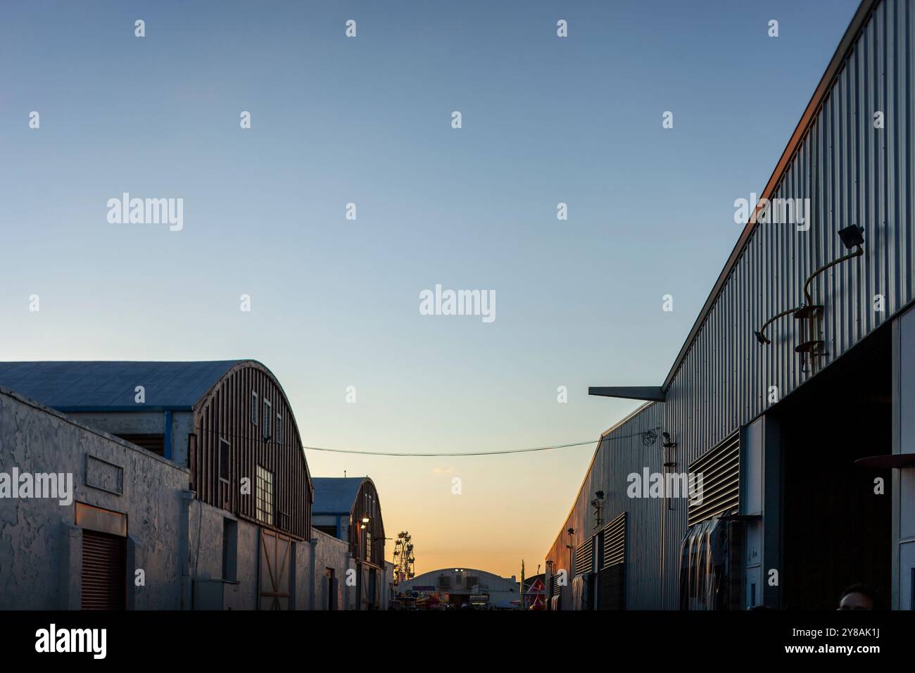Sunset on domed corrugated steel buildings at fairgrounds Stock Photo ...