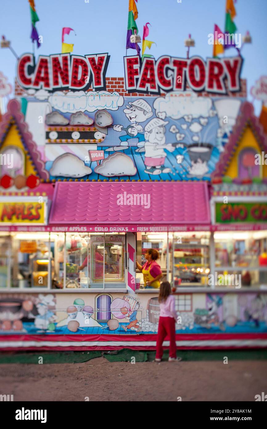 Little kid getting candy apple at Candy Factory selective focus Stock ...