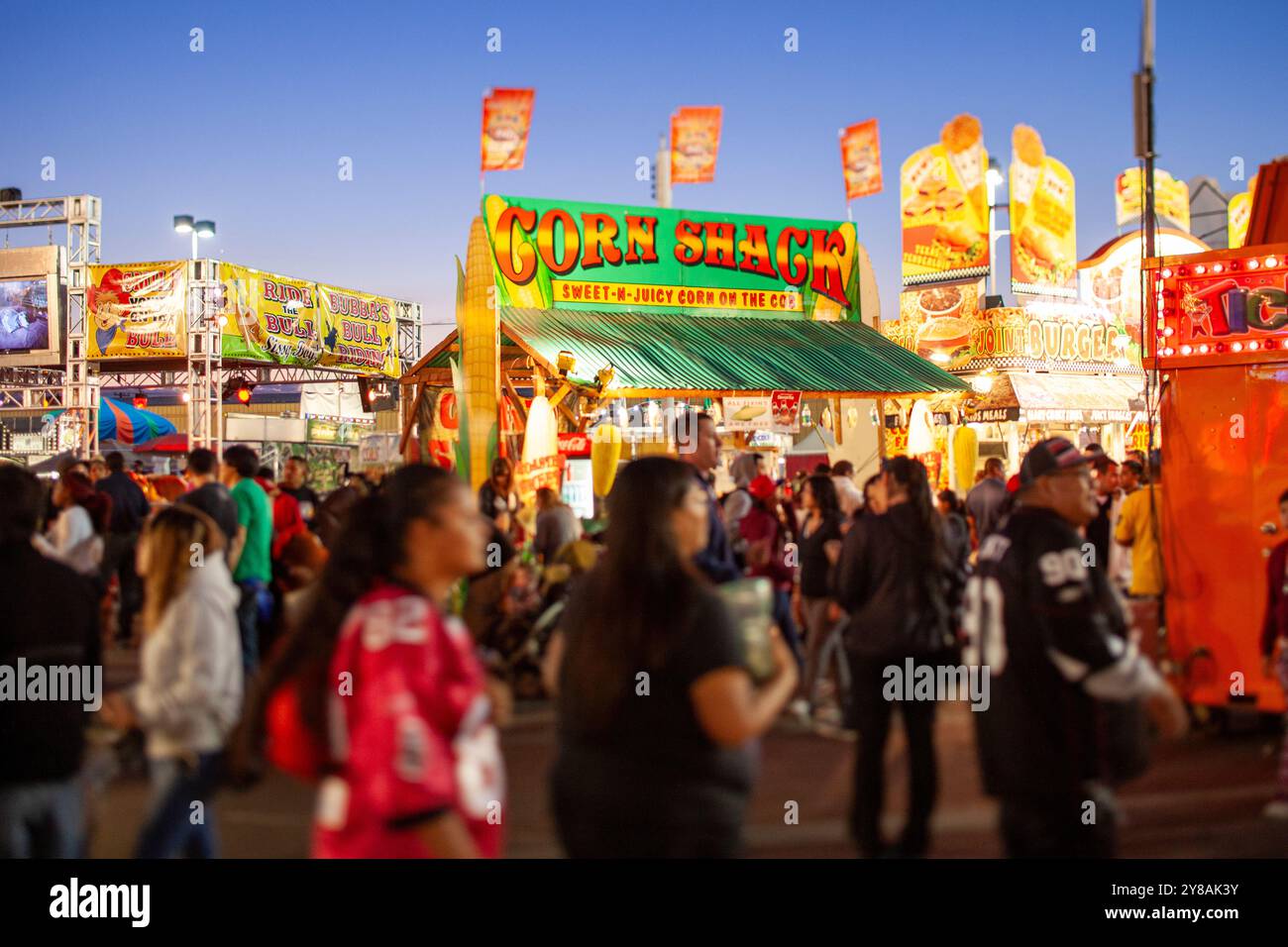 State fair crowded around Corn Shack kiosk at night Stock Photo - Alamy