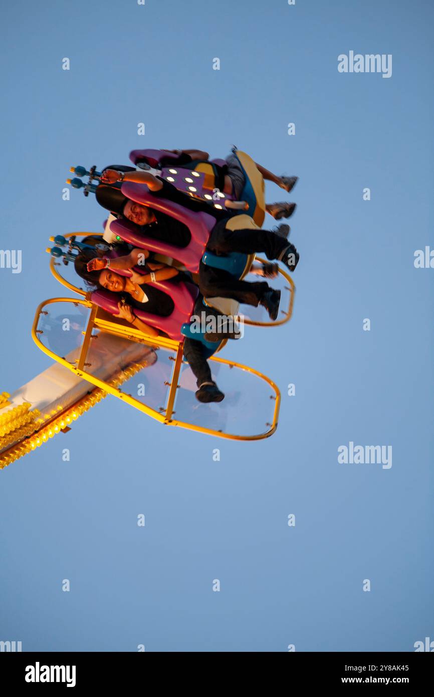 People hanging on in the air on carnival ride Stock Photo - Alamy
