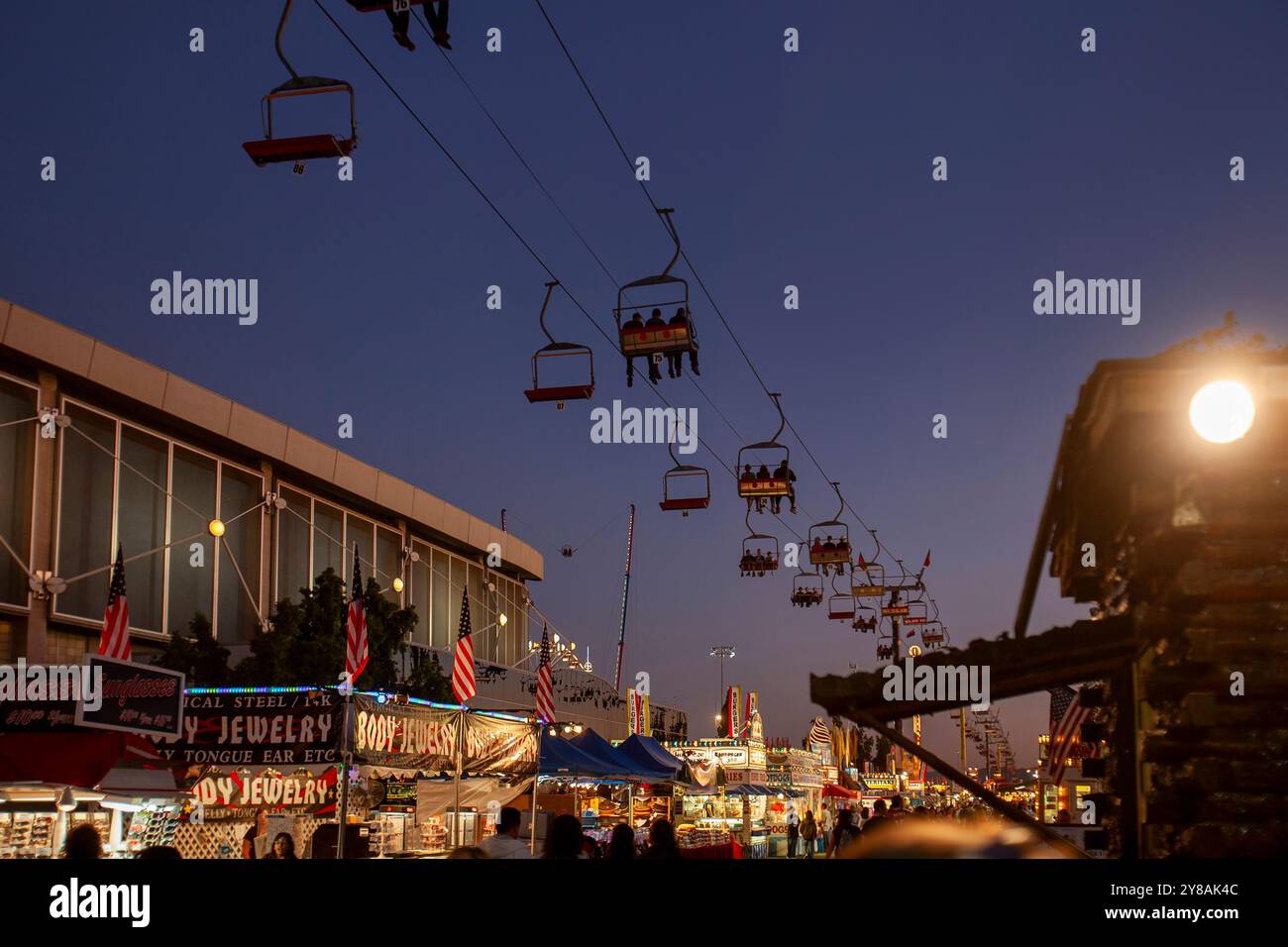 County fair grounds ski lift, games, vendors at night Stock Photo - Alamy
