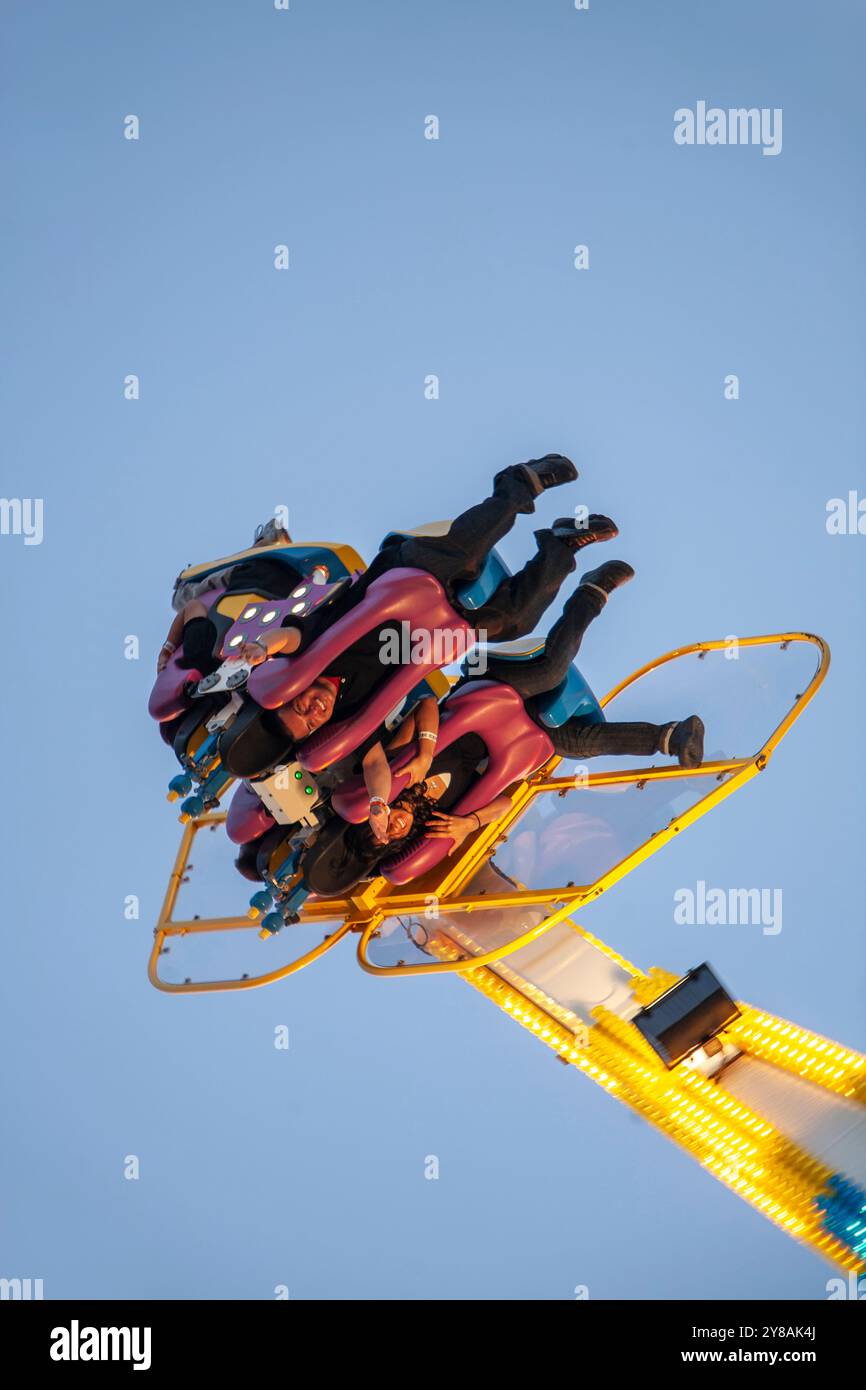 People upside down in the air on carnival ride Stock Photo - Alamy