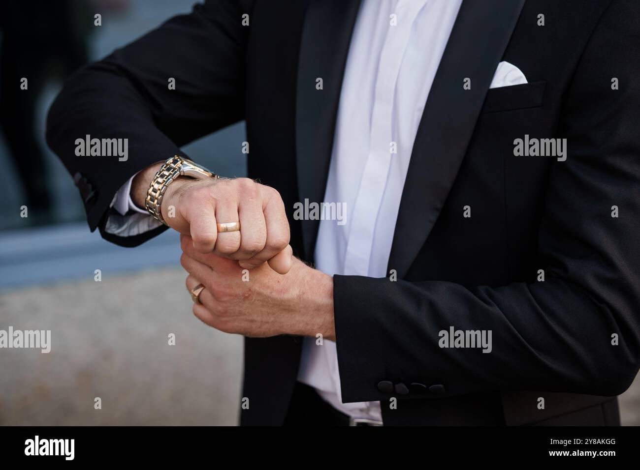 Elegant Groom Adjusting Cufflinks at Formal Event Stock Photo - Alamy