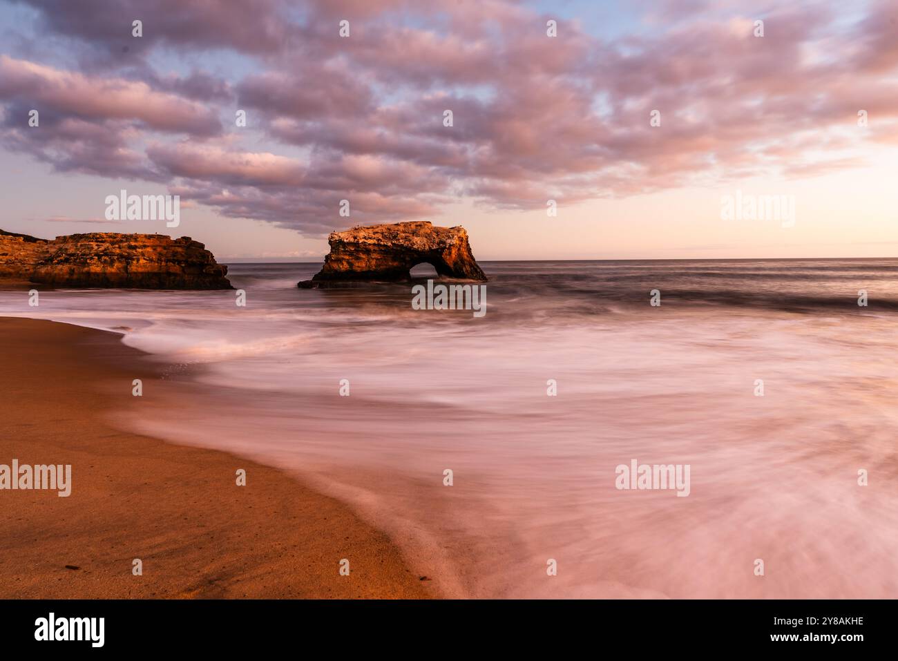 Natural Bridges at sunset with smooth waves and a pastel sky Stock ...