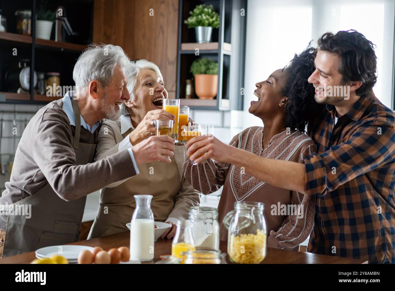Multi generation multiethnic family having fun, talking around a ...