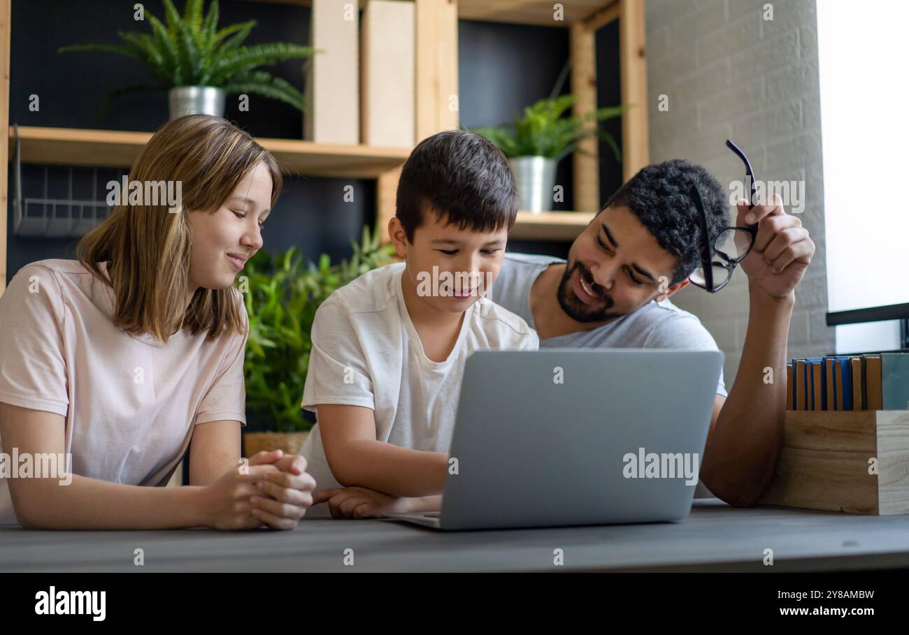 Happy multiethnic family. African american parent helping teenager kids ...